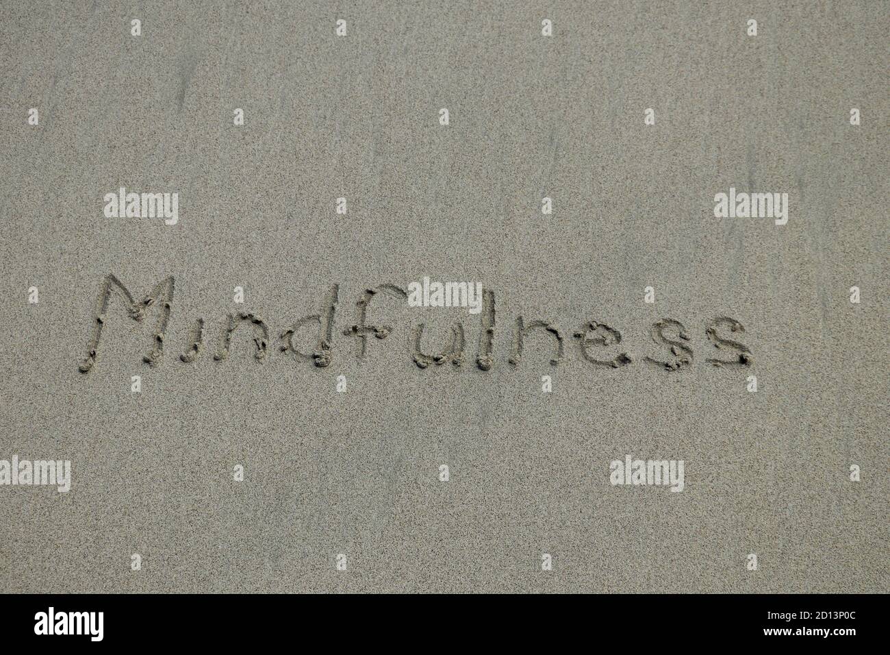 mindfulness concept, mindful living, text written on the sand of beach ...