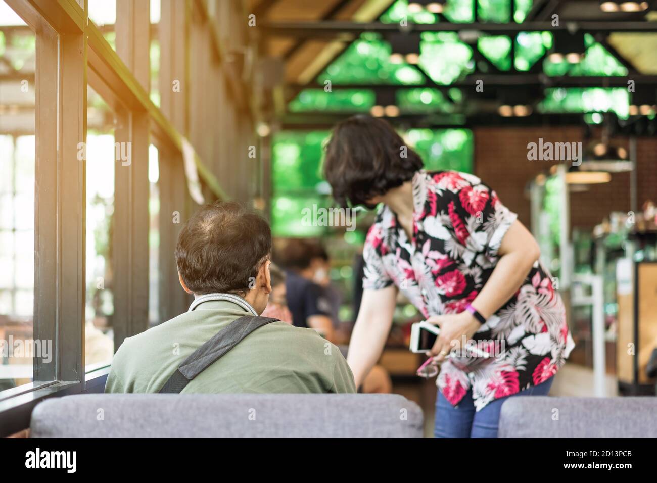 Back view of Asian male customer sit in waiting social distance queue ...
