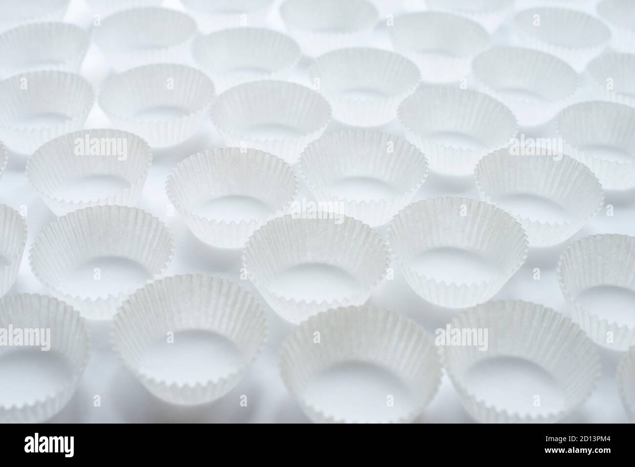 Empty paper cupcakes molds on white background Stock Photo - Alamy