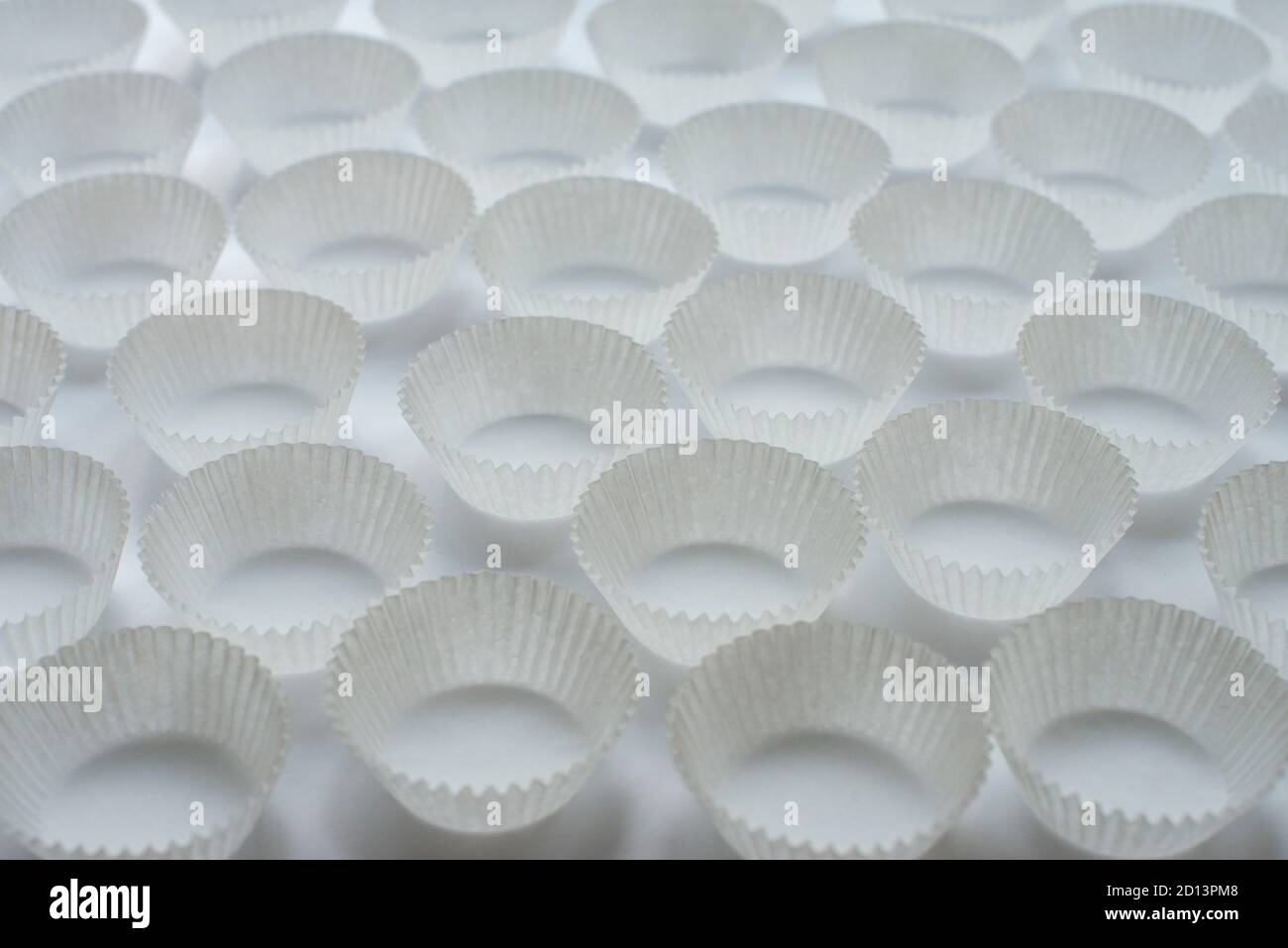 Empty paper cupcakes molds on white background Stock Photo - Alamy