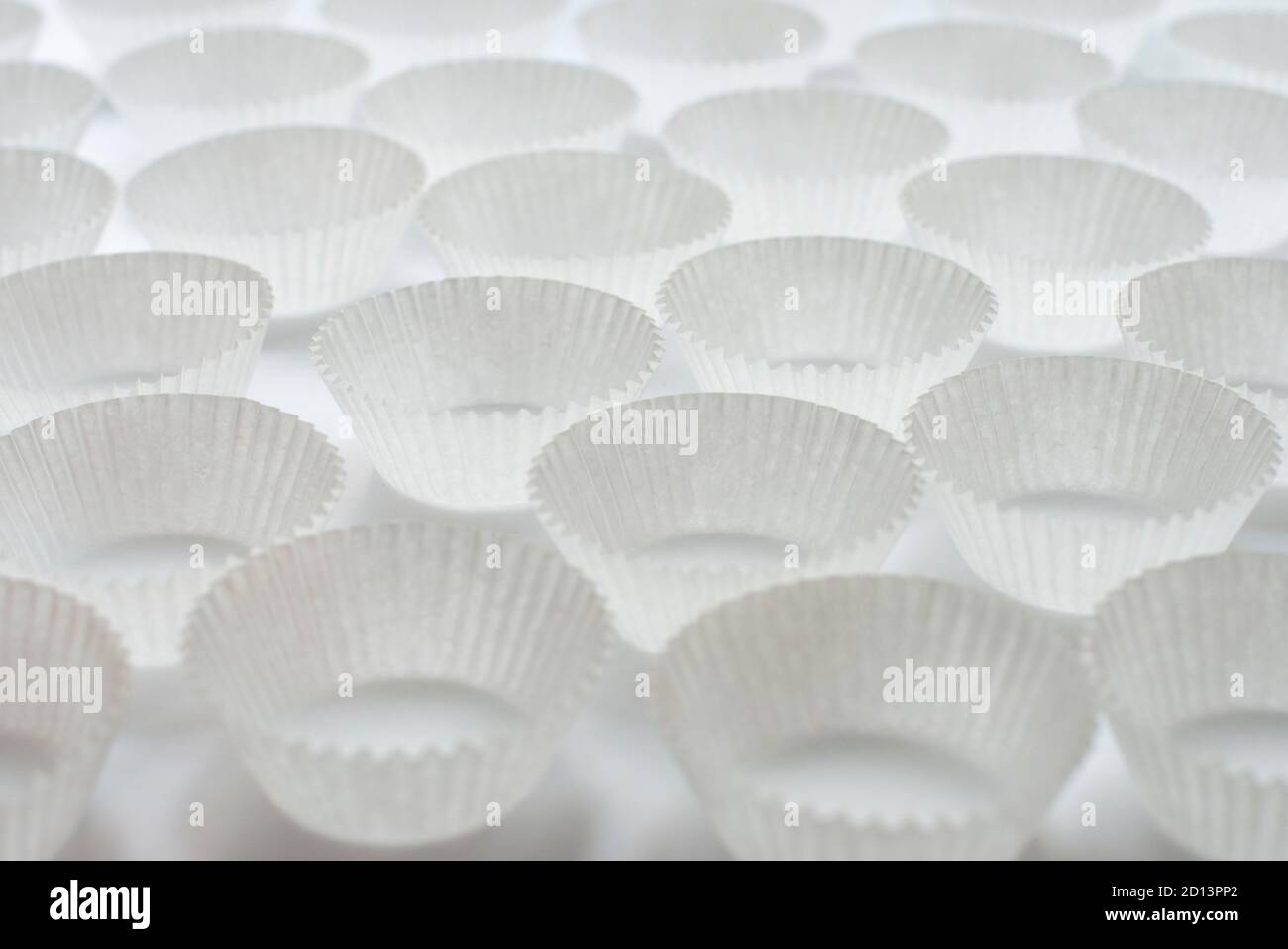 Empty paper cupcakes molds on white background Stock Photo - Alamy