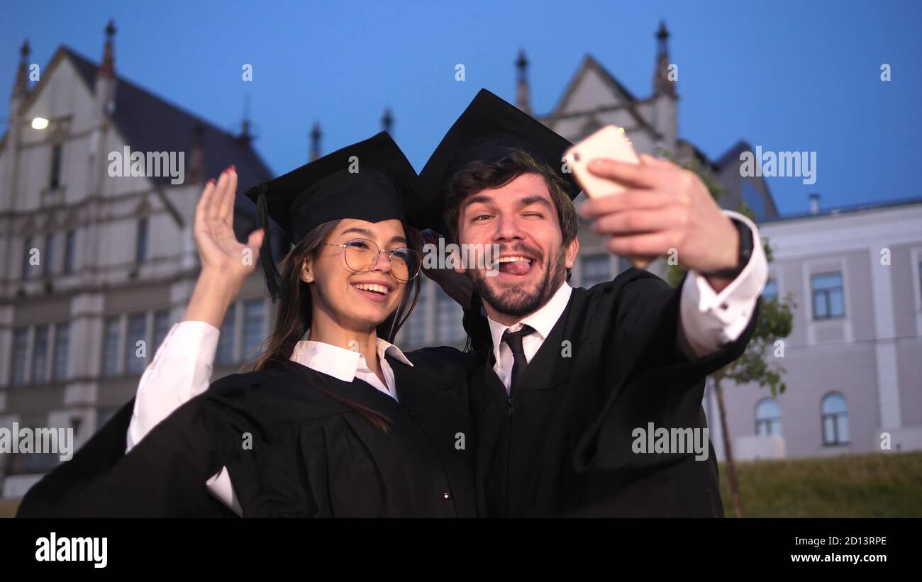 Happy male and female graduate students taking a selfie Stock Photo - Alamy