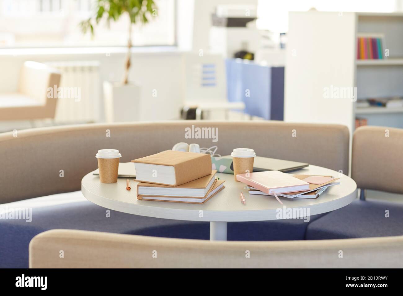 Background image of round table in library with studying supplies ...