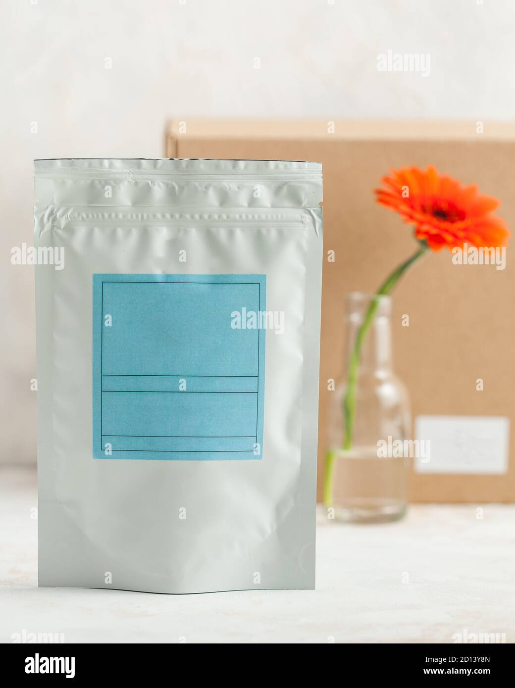 grey packaging for tea and loose substances with blue markings, in the ...