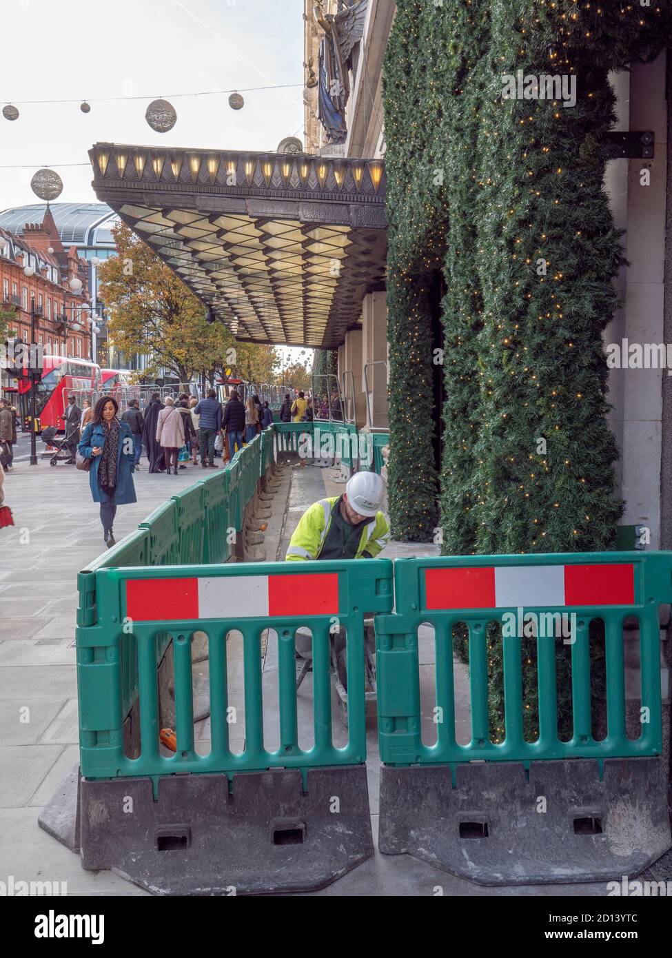 Worker seen on the walkway cordoned off for updating pavement Stock ...