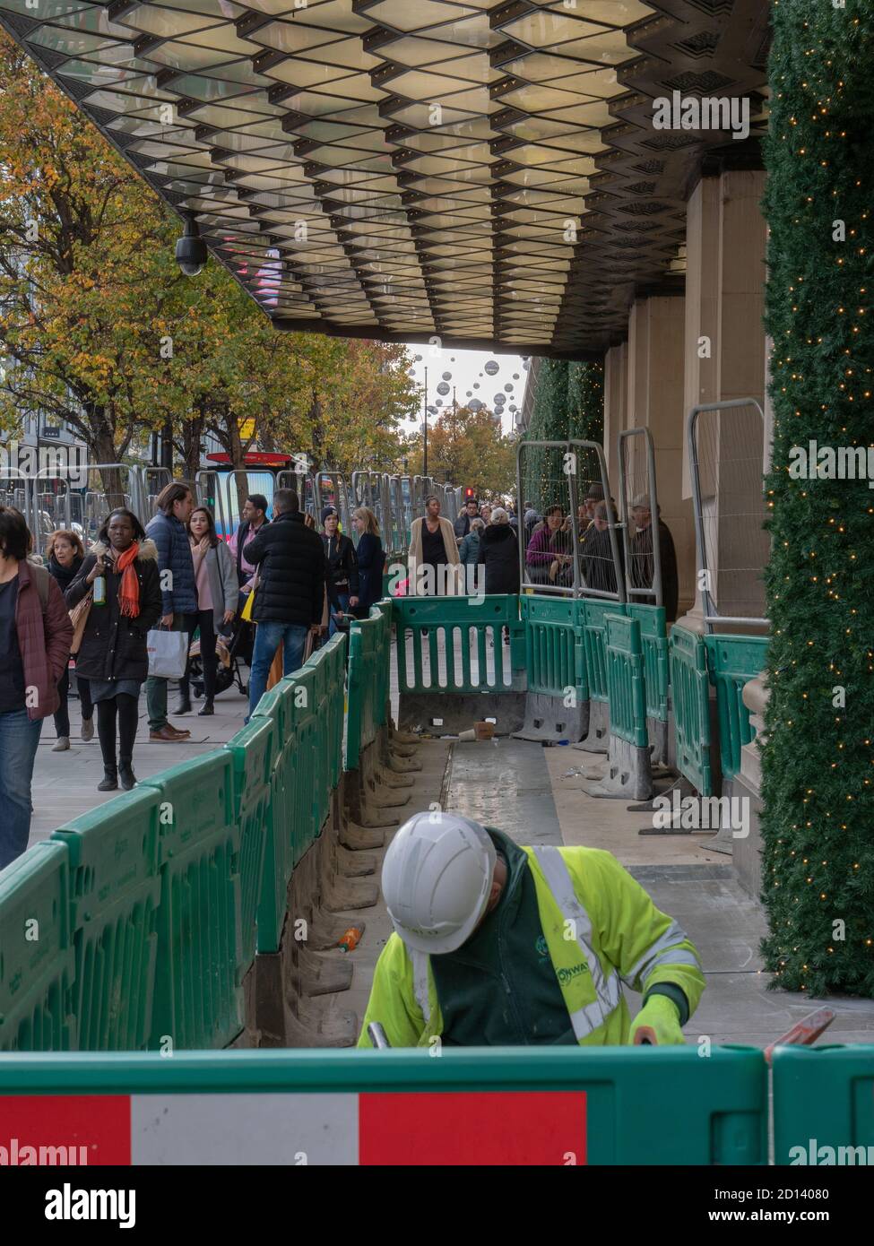 Worker seen on the walkway cordoned off for updating pavement Stock ...