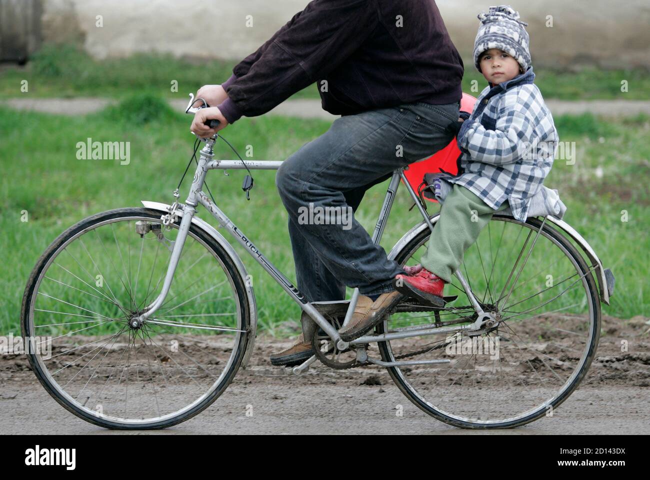Boy riding a bicycle on a dirt road hi-res stock photography and images ...