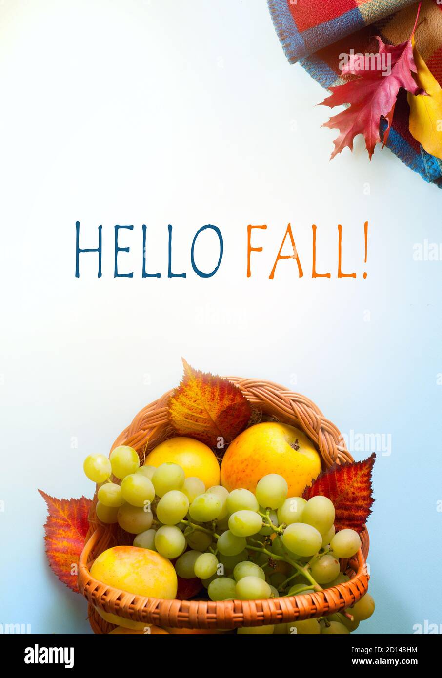 Hello fall message with Autumn leaves, seasonal fruit and Warm scarf on ...