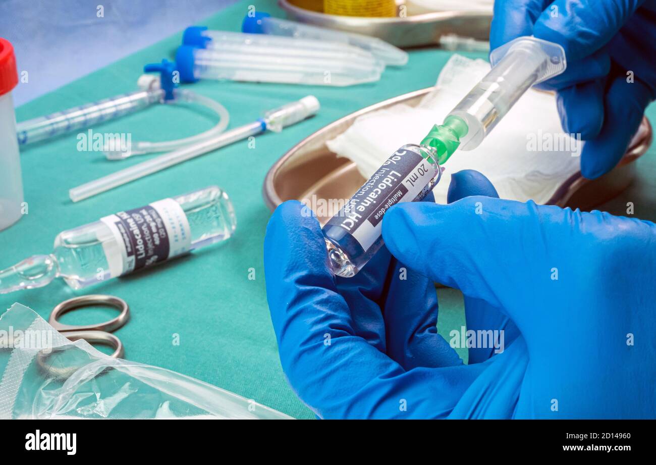 Nurse holds ampoule of anesthesia, preparation to extract cerebrospinal ...