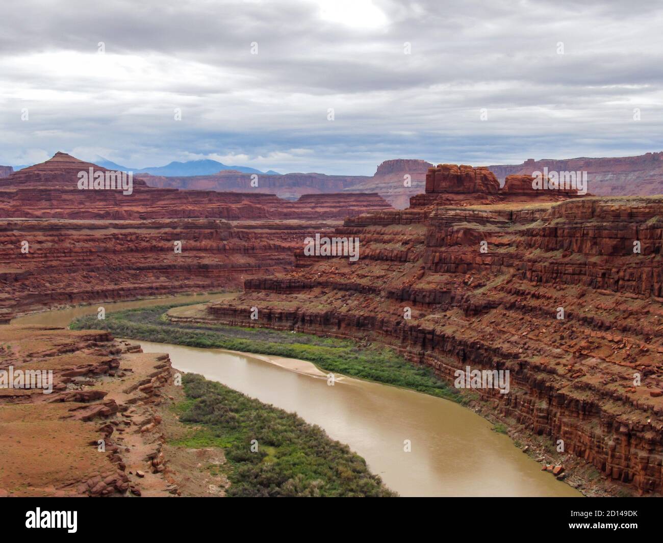 The Colorado River, were it cut a canyon through the red colored cliffs ...