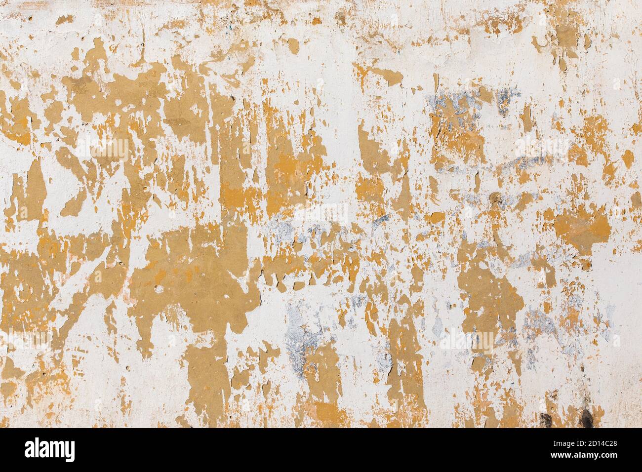 Shabby flat plaster and painted wall with big yellow under layer spots ...