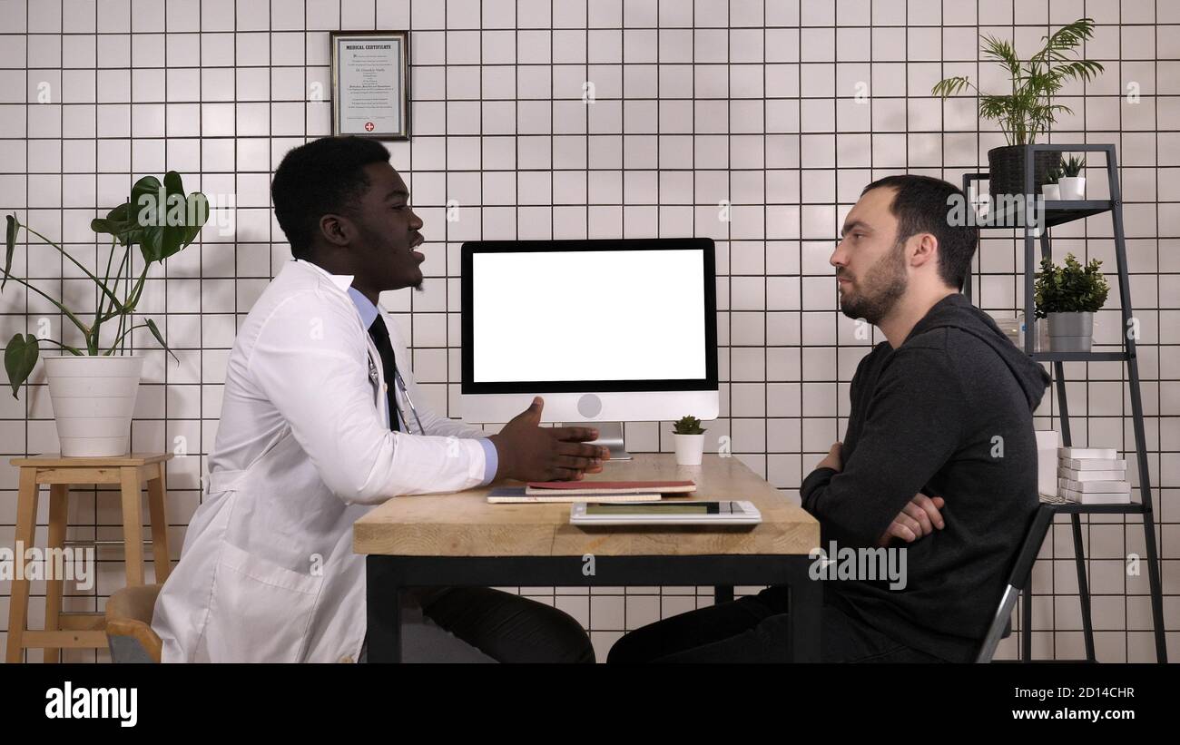 Doctor showing medical records on his computer to his patient, h Stock ...