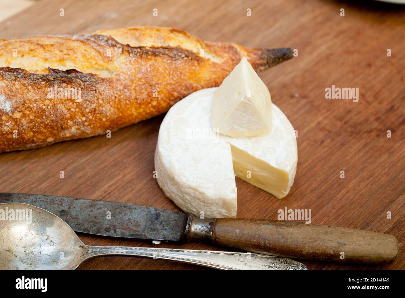 French cheese and fresh baguette on a wood cutter Stock Photo - Alamy
