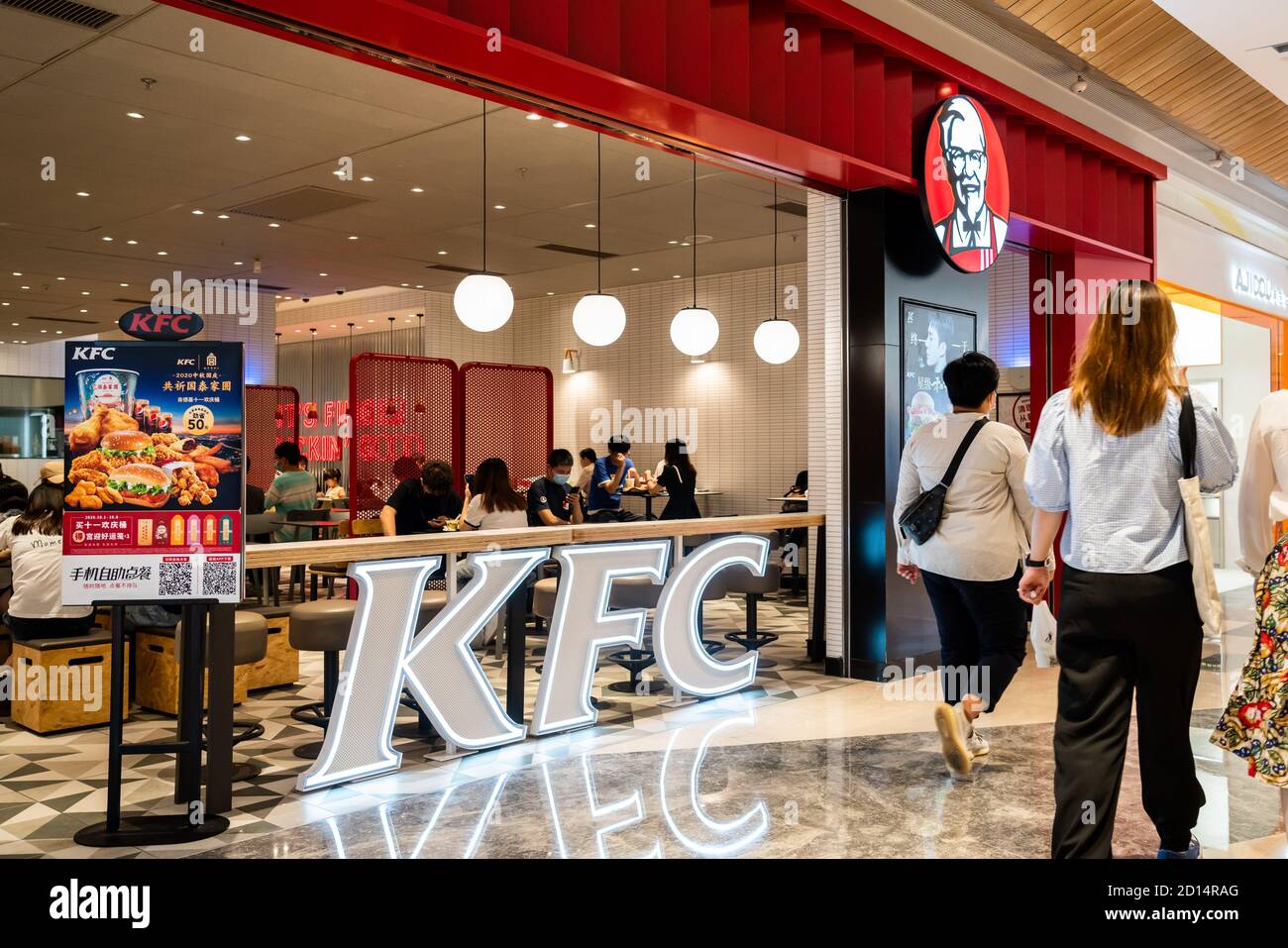 Pedestrians walk past an American fast food restaurant chain, Kentucky ...
