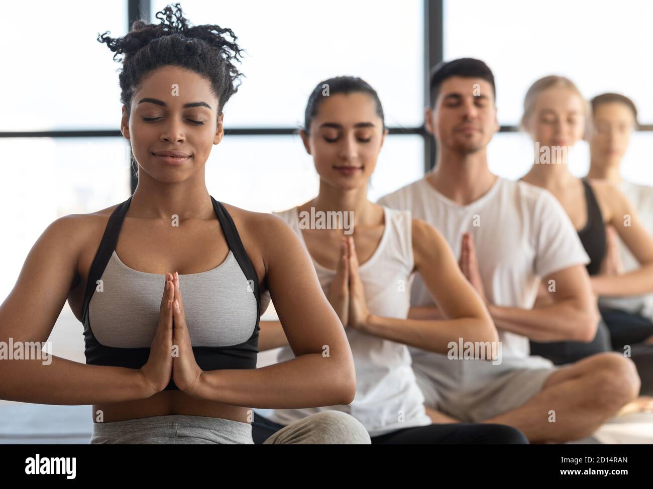 Yoga Class. Young Sporty Multicultural People Sitting In A Row ...