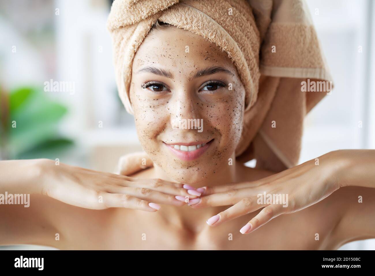 Skin care, young woman applying scrub on face in bathroom Stock Photo ...