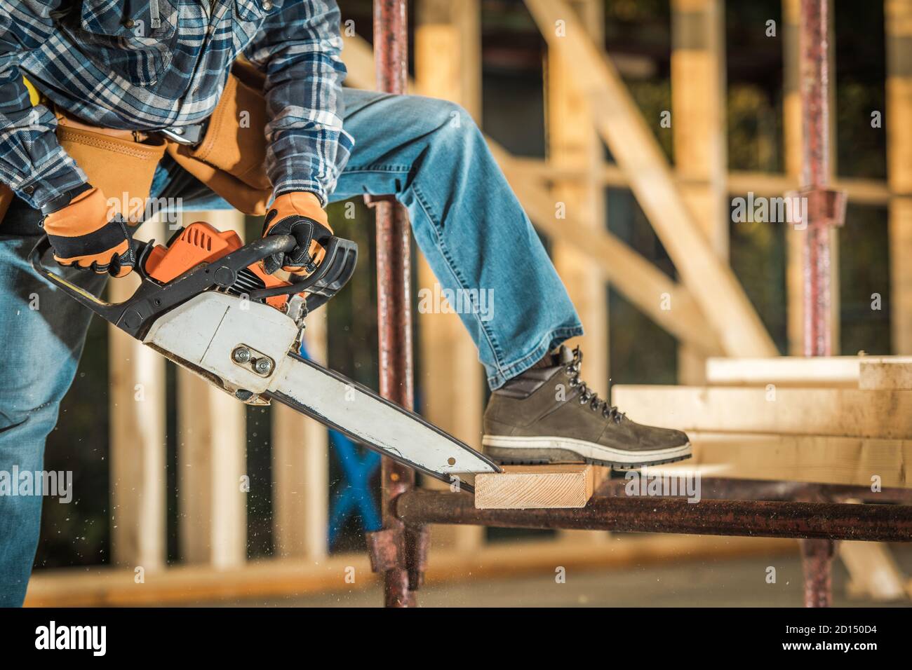 Construction Contractor Cutting Wood Board Using Powerful Chainsaw ...