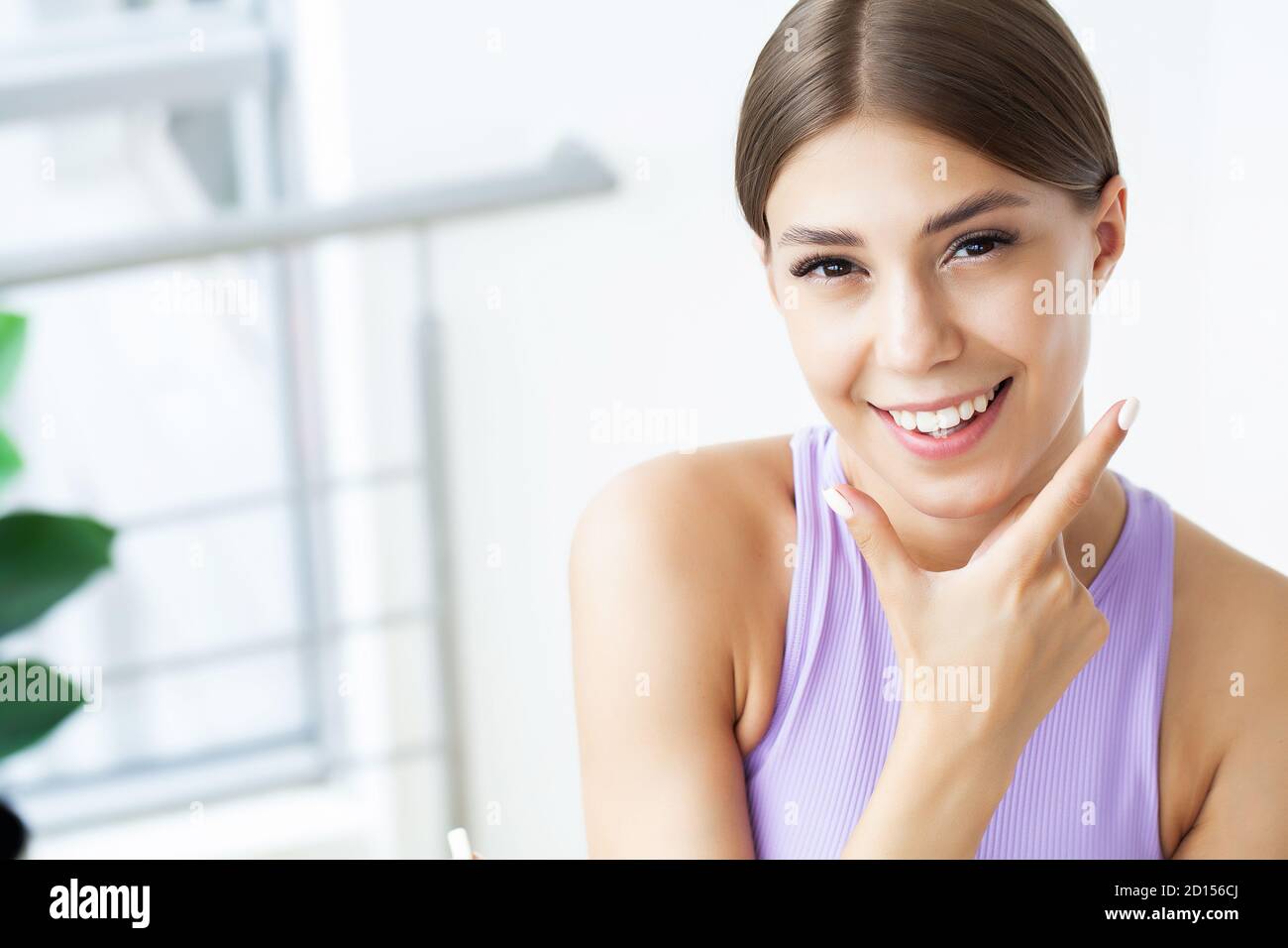 Partial portrait of girl with strong white teeth looking at camera and ...