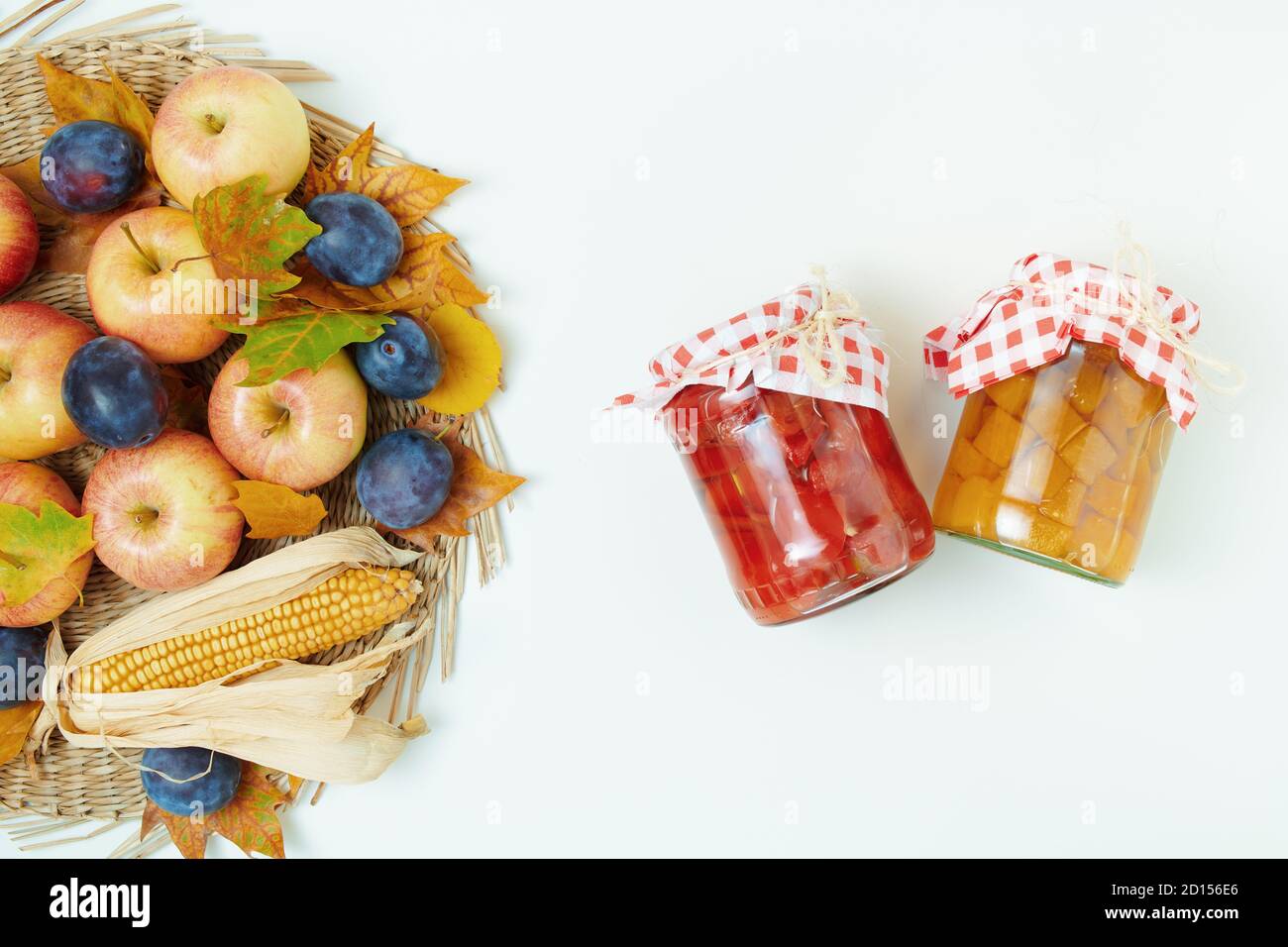 Hello october. autumn flat lay with leaves, plums, apples and canned ...