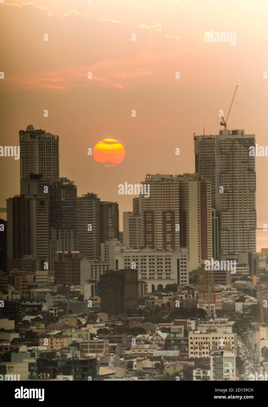 sunset against the high rise buildings in Manila Stock Photo - Alamy