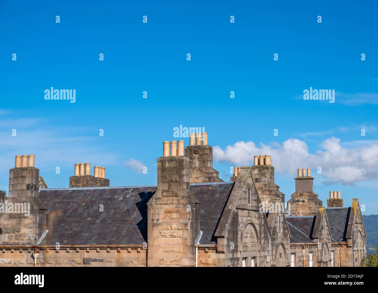 Veiw of rooftop chimney stacks stone built with blue sky background ...