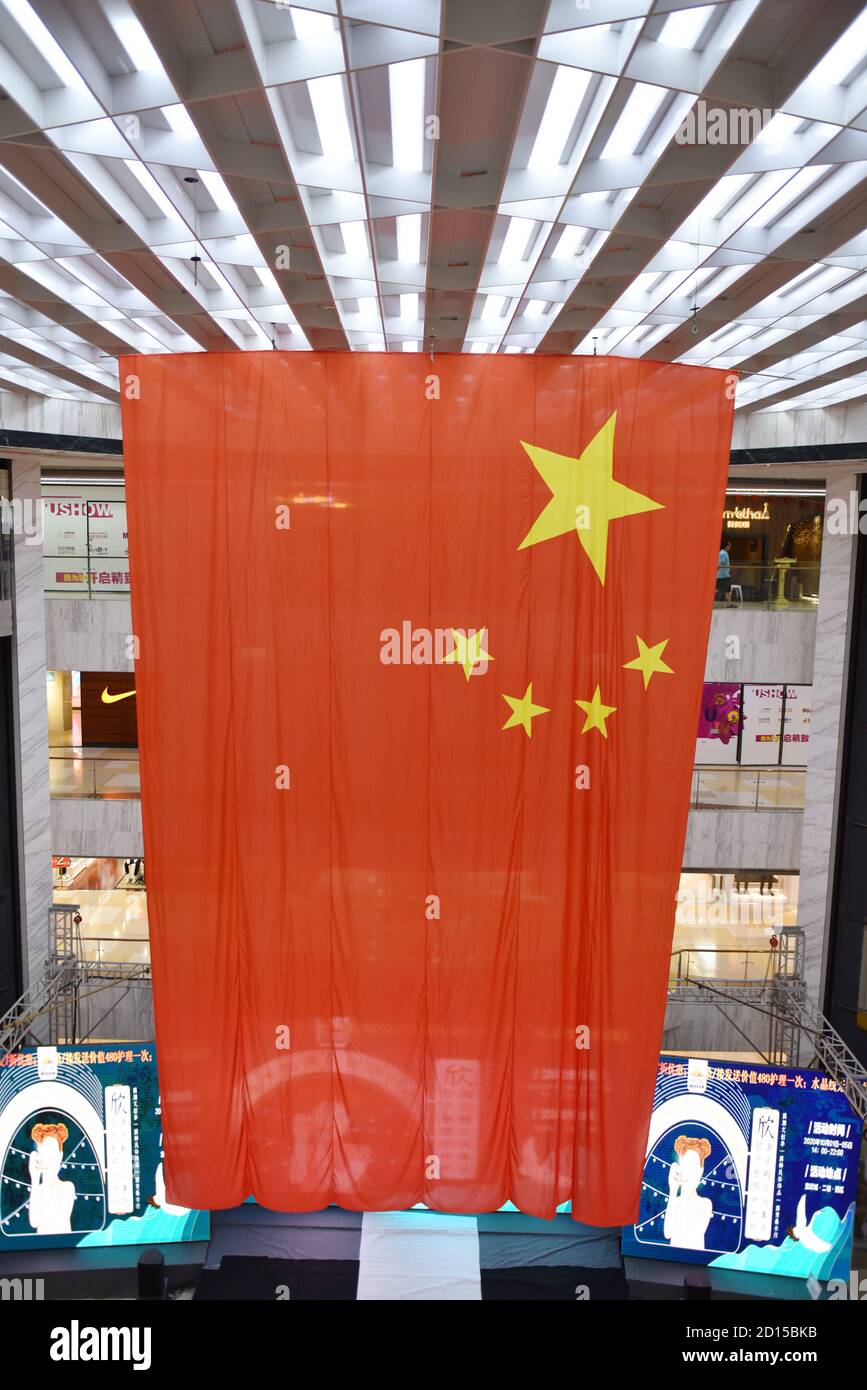 Haikou, China. 02nd Oct, 2020. A huge Chinese flag is seen flying at Yi ...