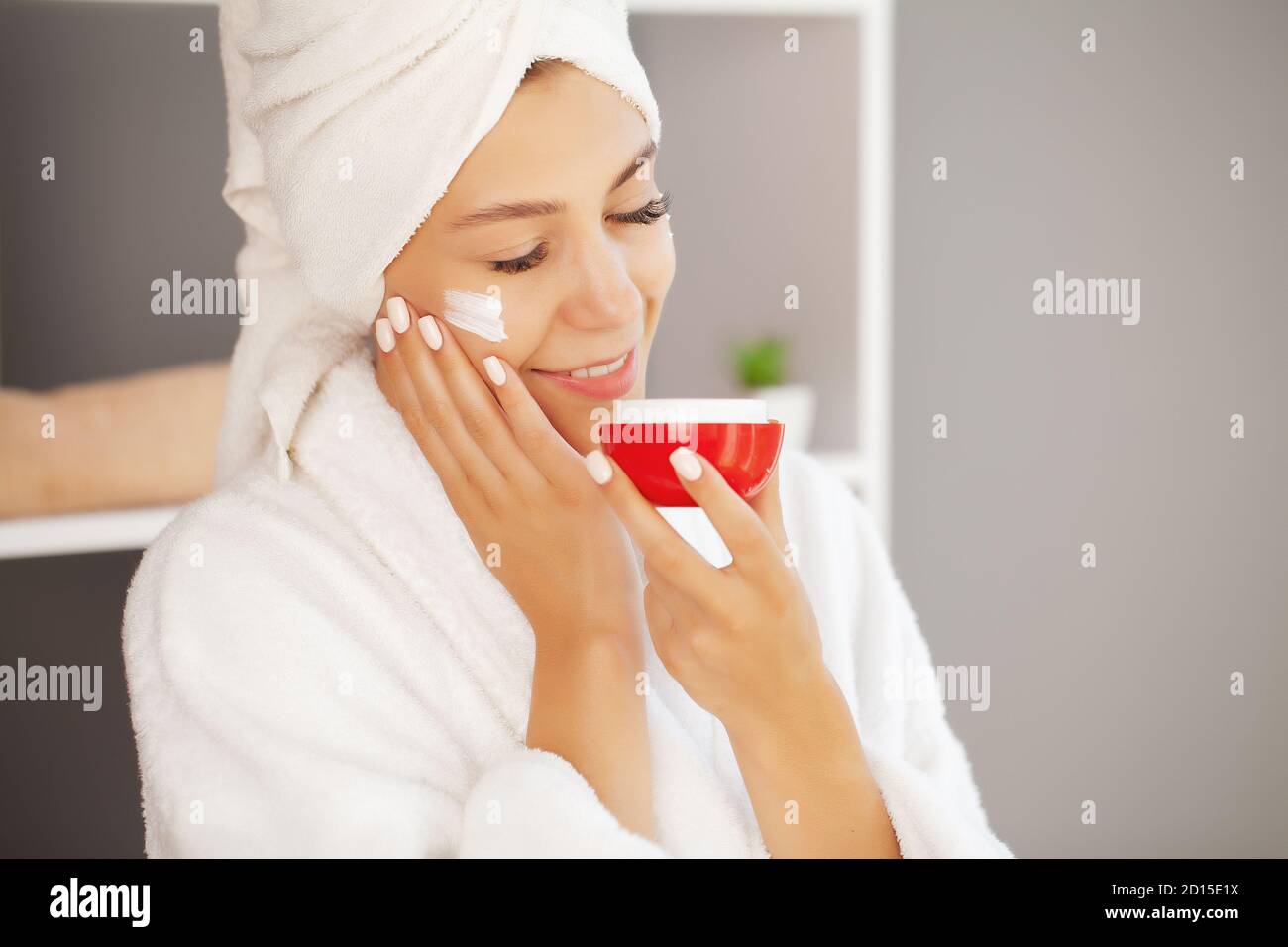 Skin care, beautiful model applying cosmetic cream treatment on her ...