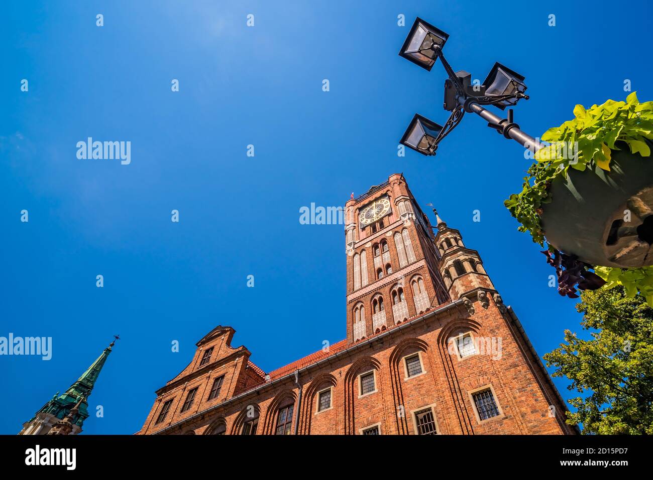 A low angle shot of the Clock Tower of Ratusz building in Torun, Poland ...