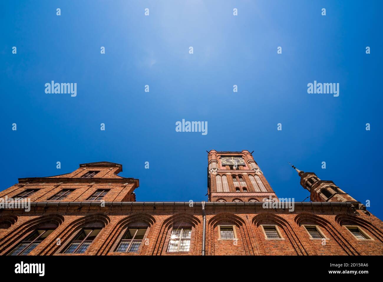 A low angle shot of the Clock Tower of Ratusz building in Torun, Poland ...