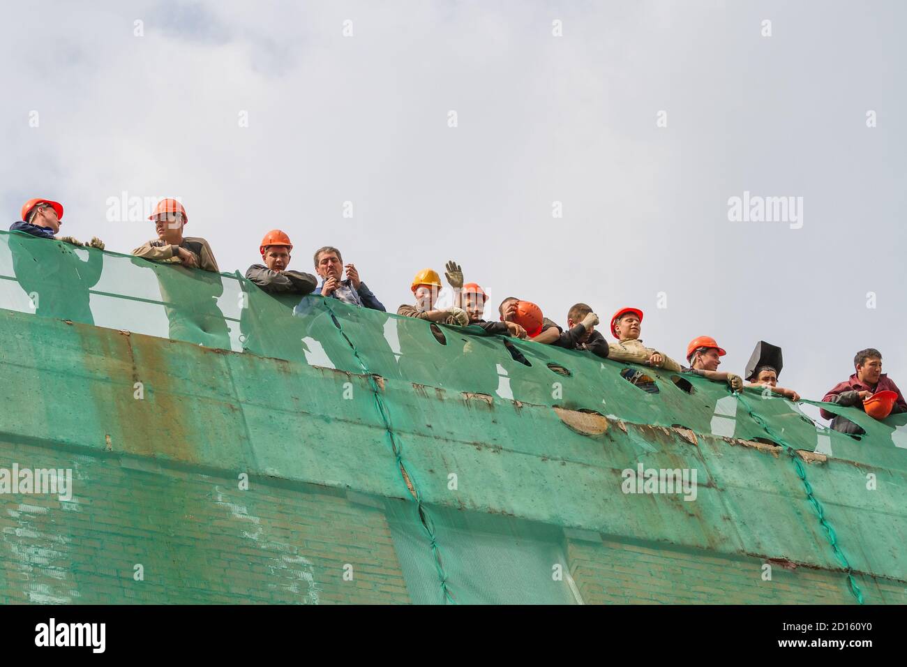 Russia. Moscow. A team of builders on the roof of a building under ...