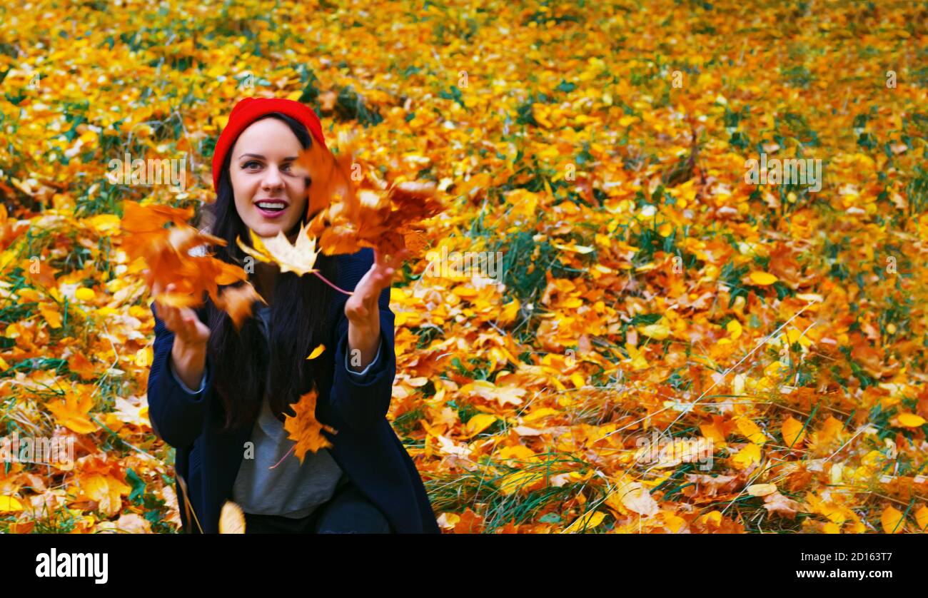 Woman throwing leaves in the air hi-res stock photography and images ...