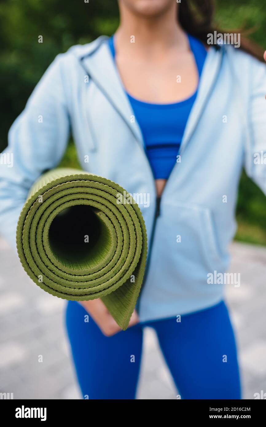 Close-up woman holding roll fitness after working Stock Photo - Alamy
