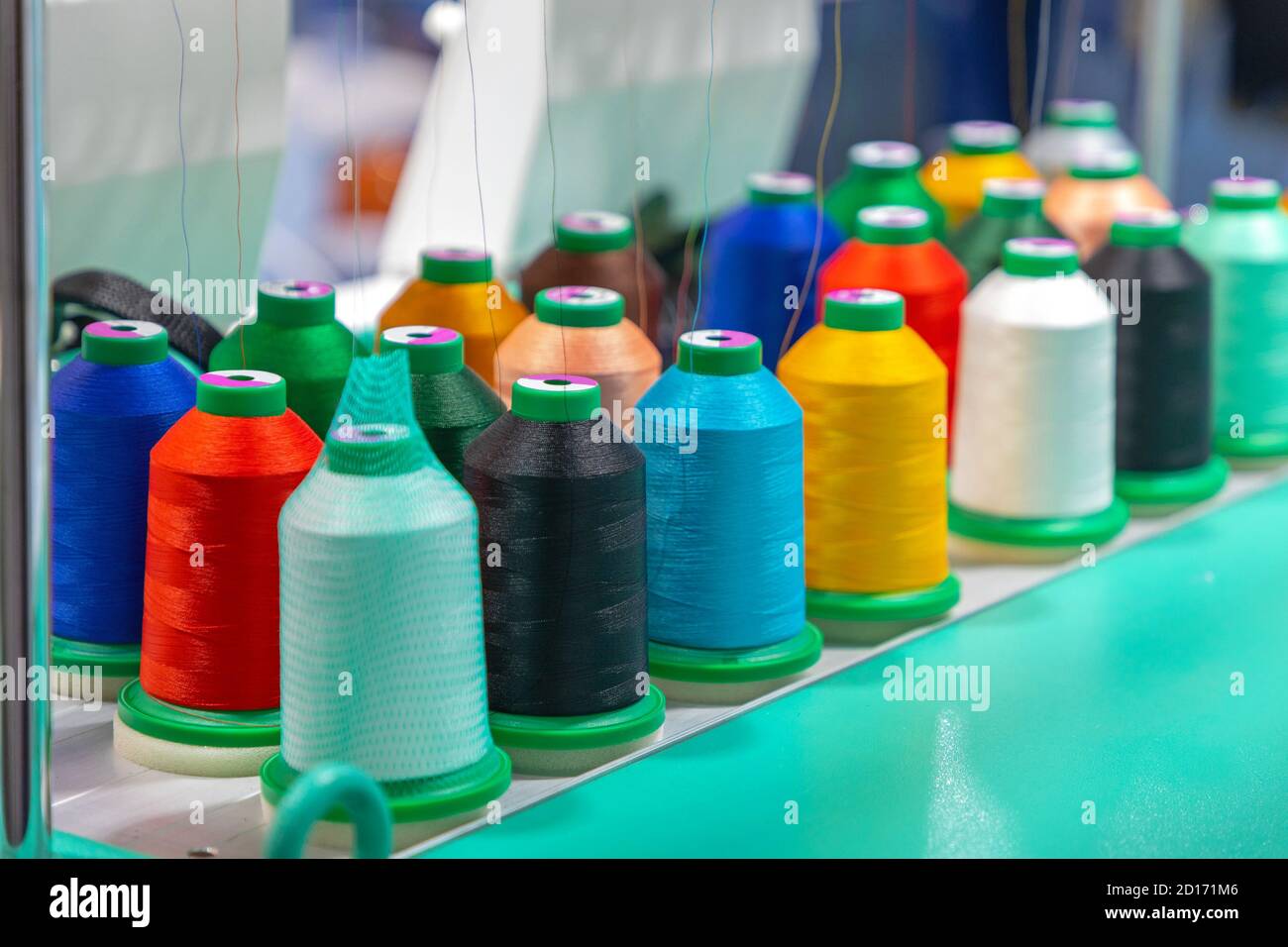 Many Colours Yarns Spools Bobbins at Sewing Machine Stock Photo - Alamy