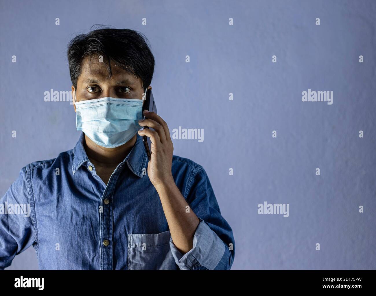 Indian man making phone call while wearing surgical nose mask Stock ...