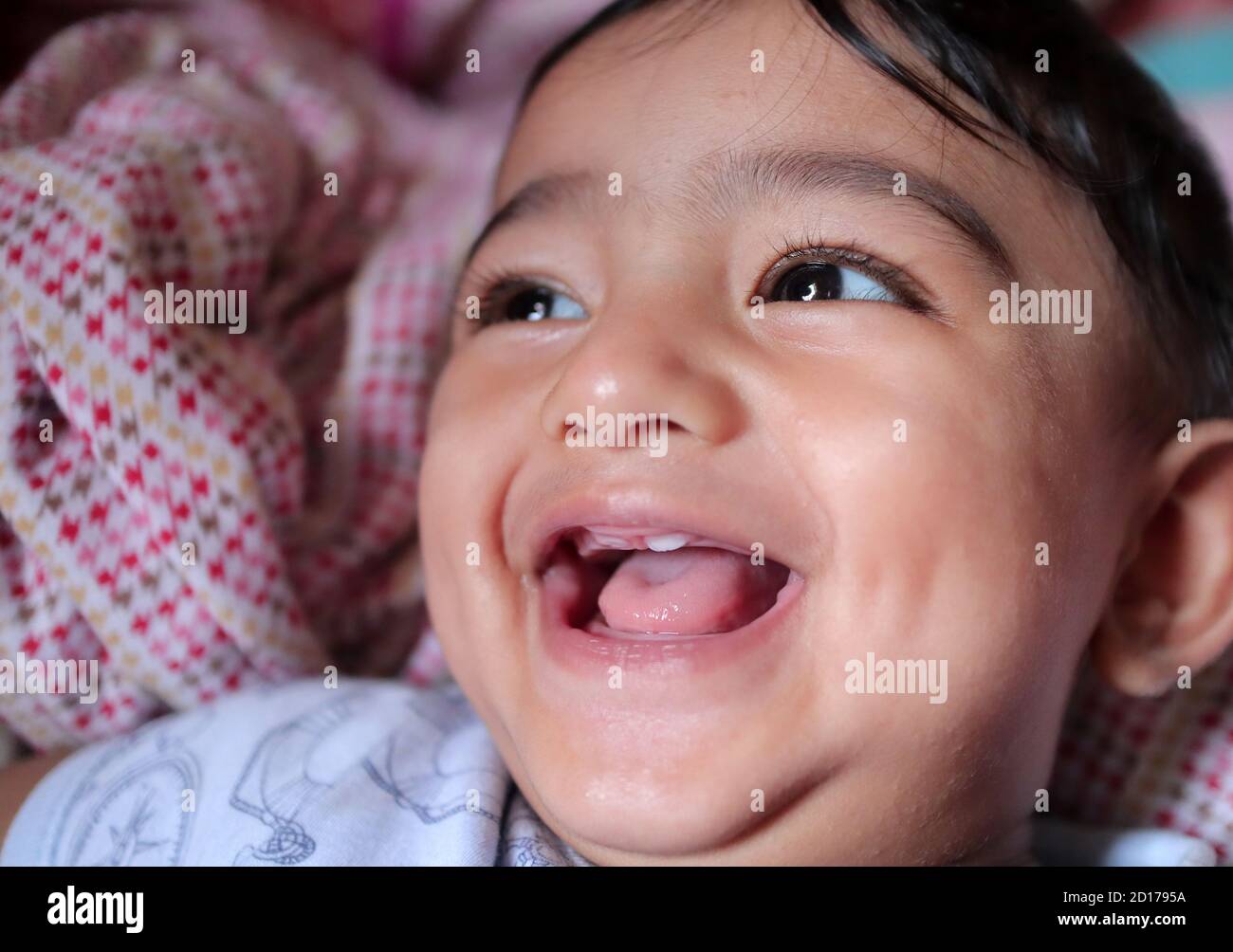 close up photo of an indian baby boy with first tooth erupted and ...