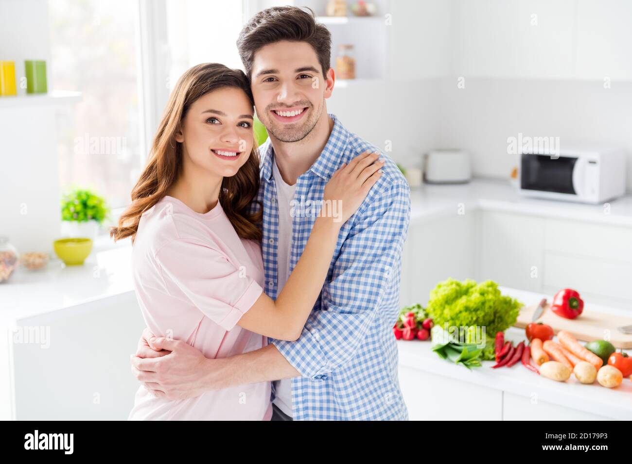 Portrait of charming bonding two people man woman hug embrace cuddle enjoy cooking cuisine ...