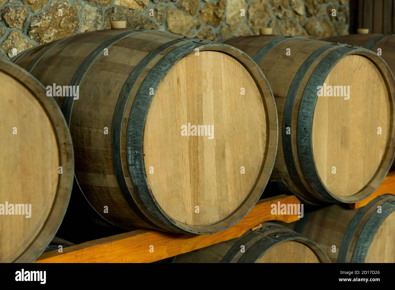 Close up photo of wine barrel laying underground, preparing winery ...