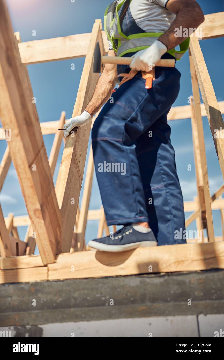 Profile photo of strong man that standing on the beam Stock Photo - Alamy