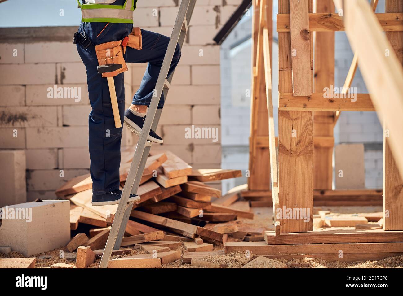 Focused photo on male person climbing the ladder Stock Photo - Alamy