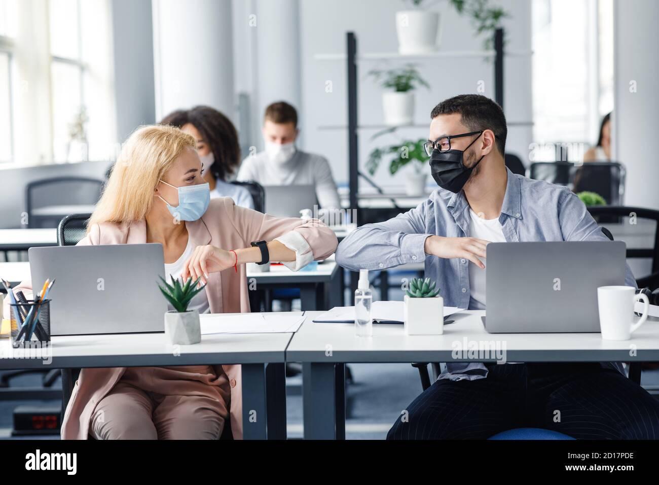 Modern high five at work after lockdown and new normal. Happy ...