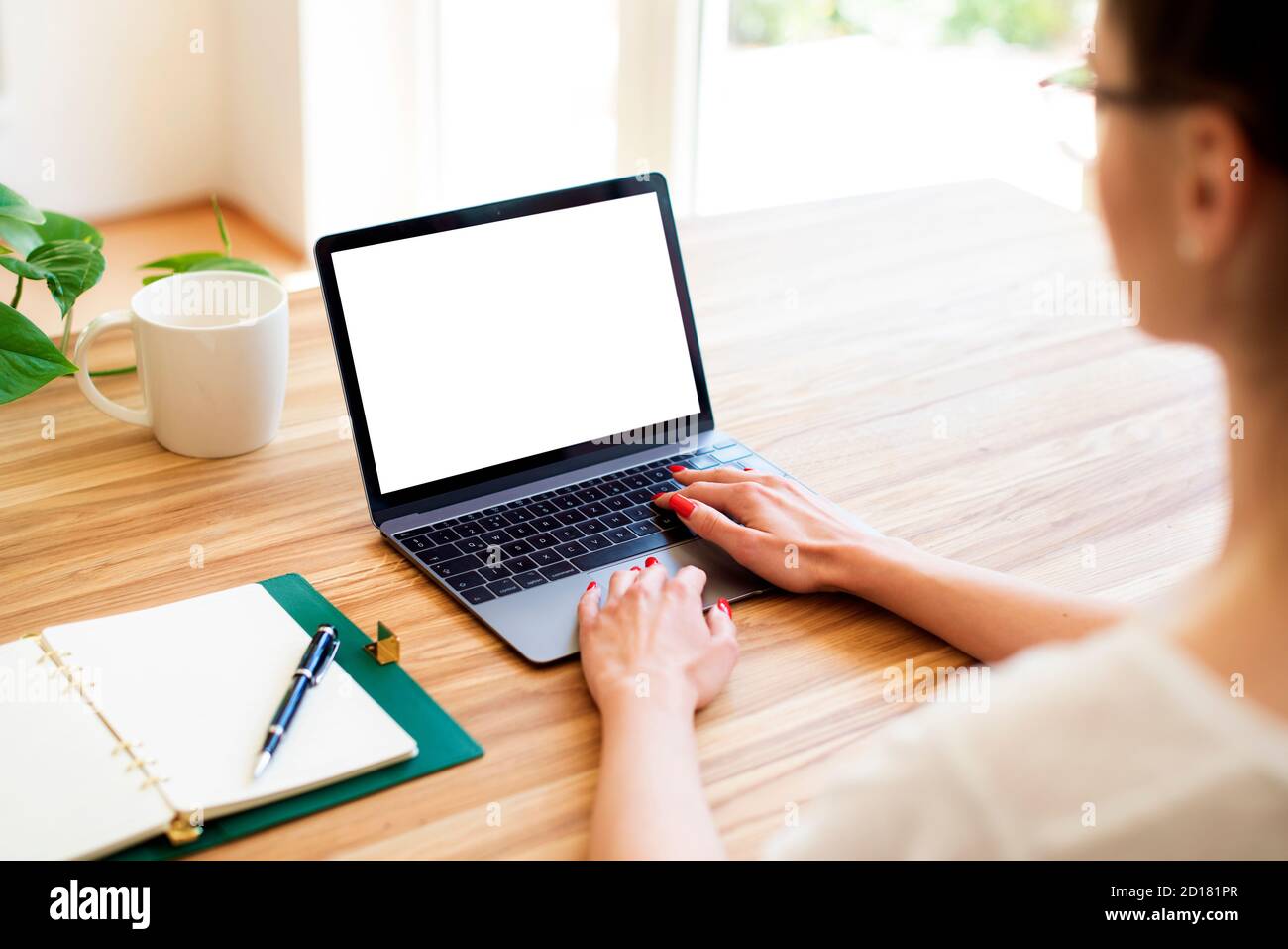 Rear view shot of businesswoman’s hand while typing on notebook on the ...
