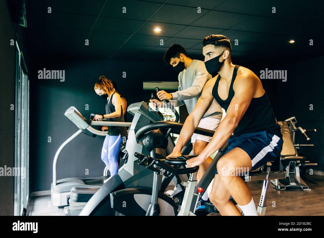 group of young people wearing face masks working out at the gym Stock ...