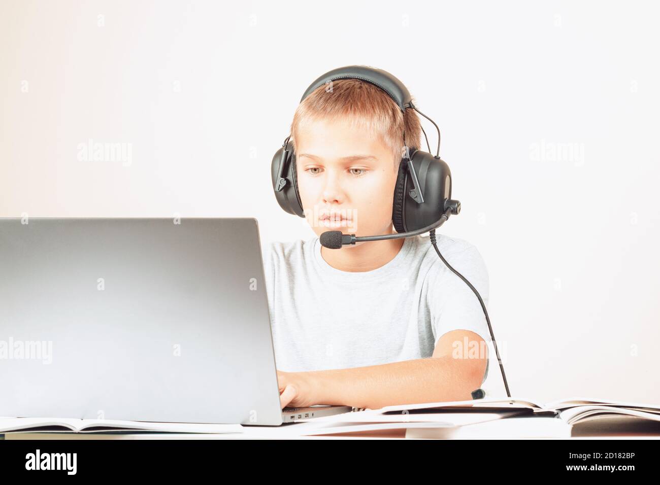 Boy in a headphones spending time with notebook at home. Online ...