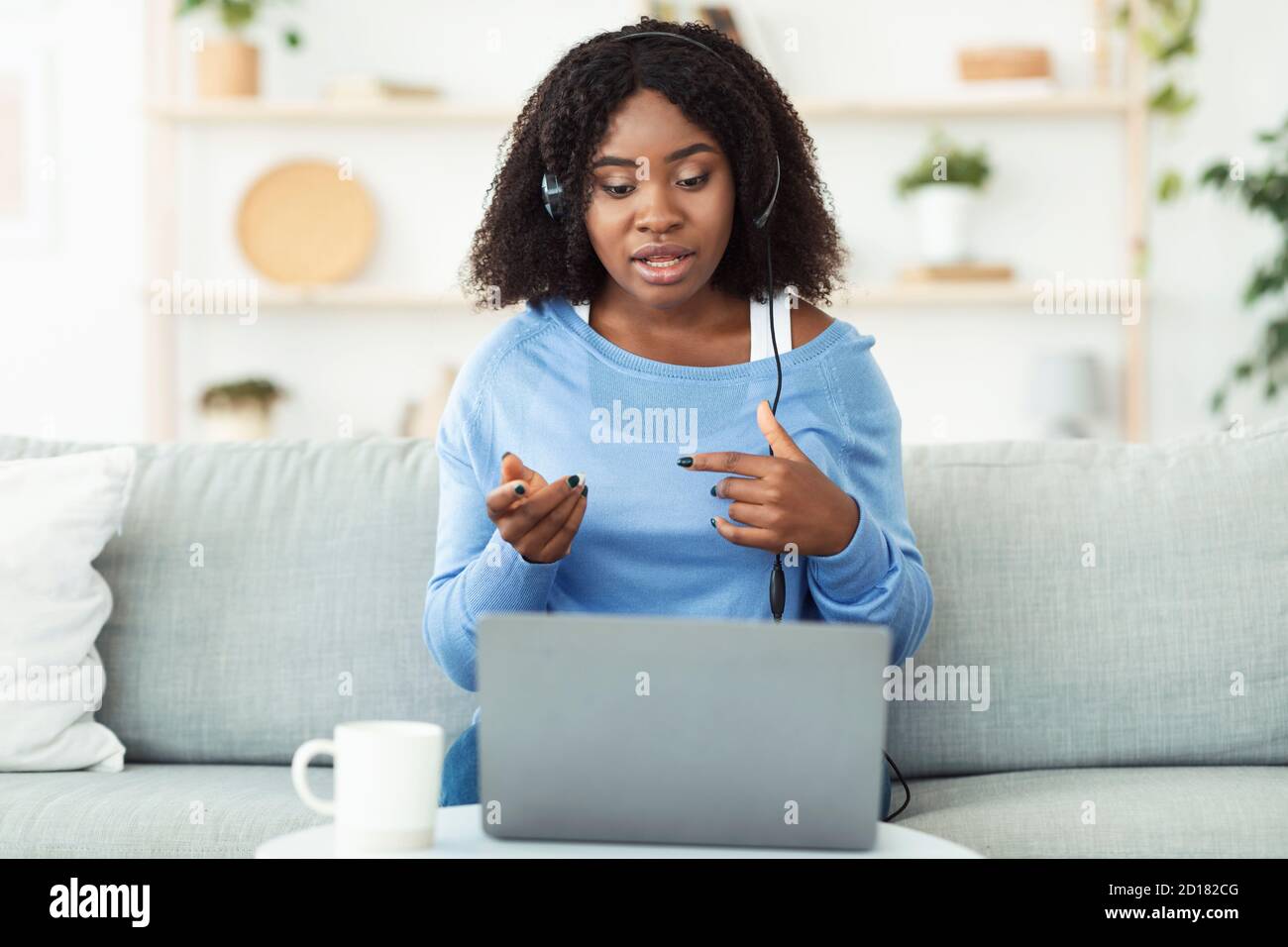 Black lady making video call with headset Stock Photo - Alamy