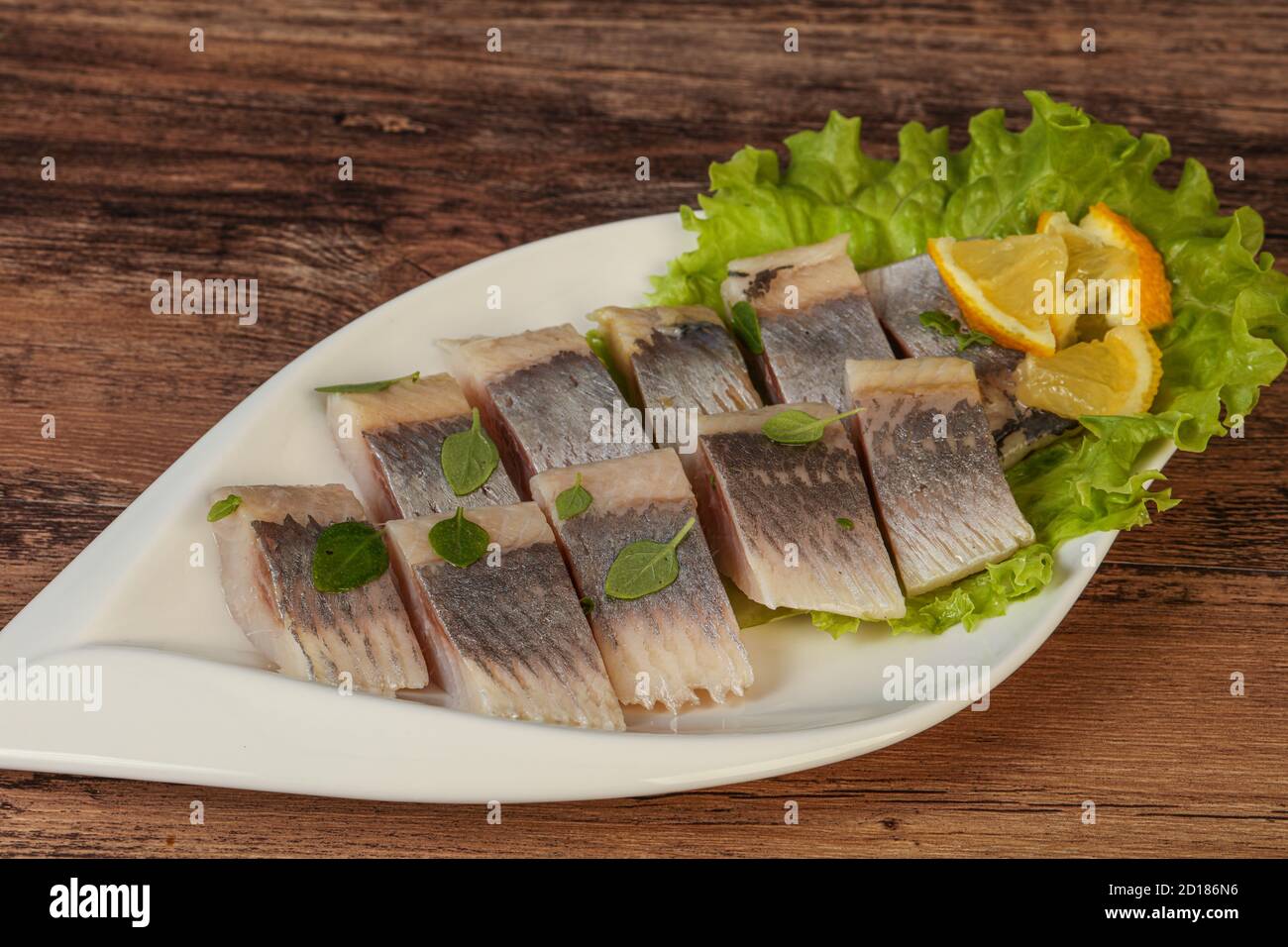 Marinated Herring fillet with sliced lemon Stock Photo - Alamy