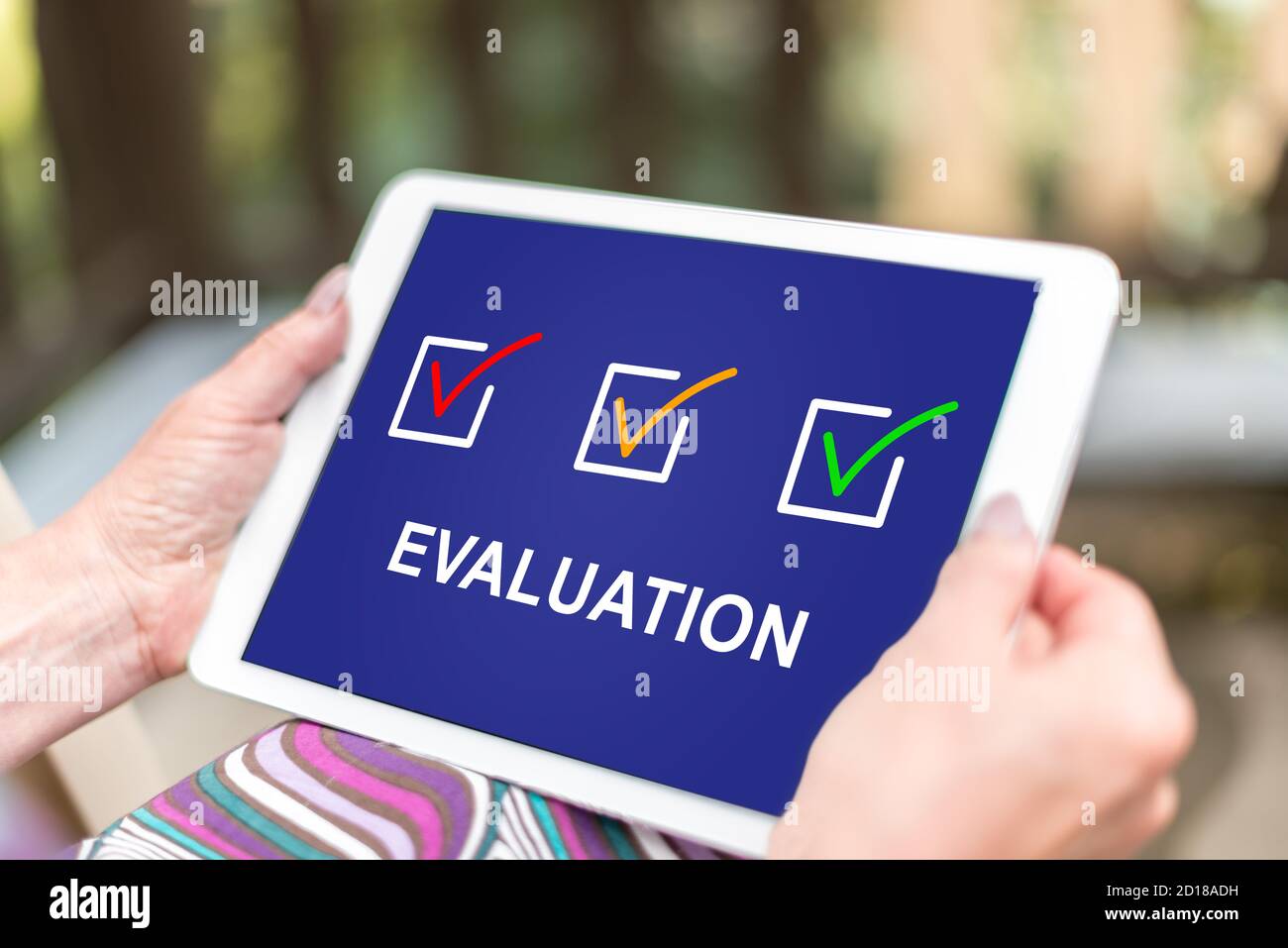 Female hands holding a tablet with evaluation concept Stock Photo - Alamy