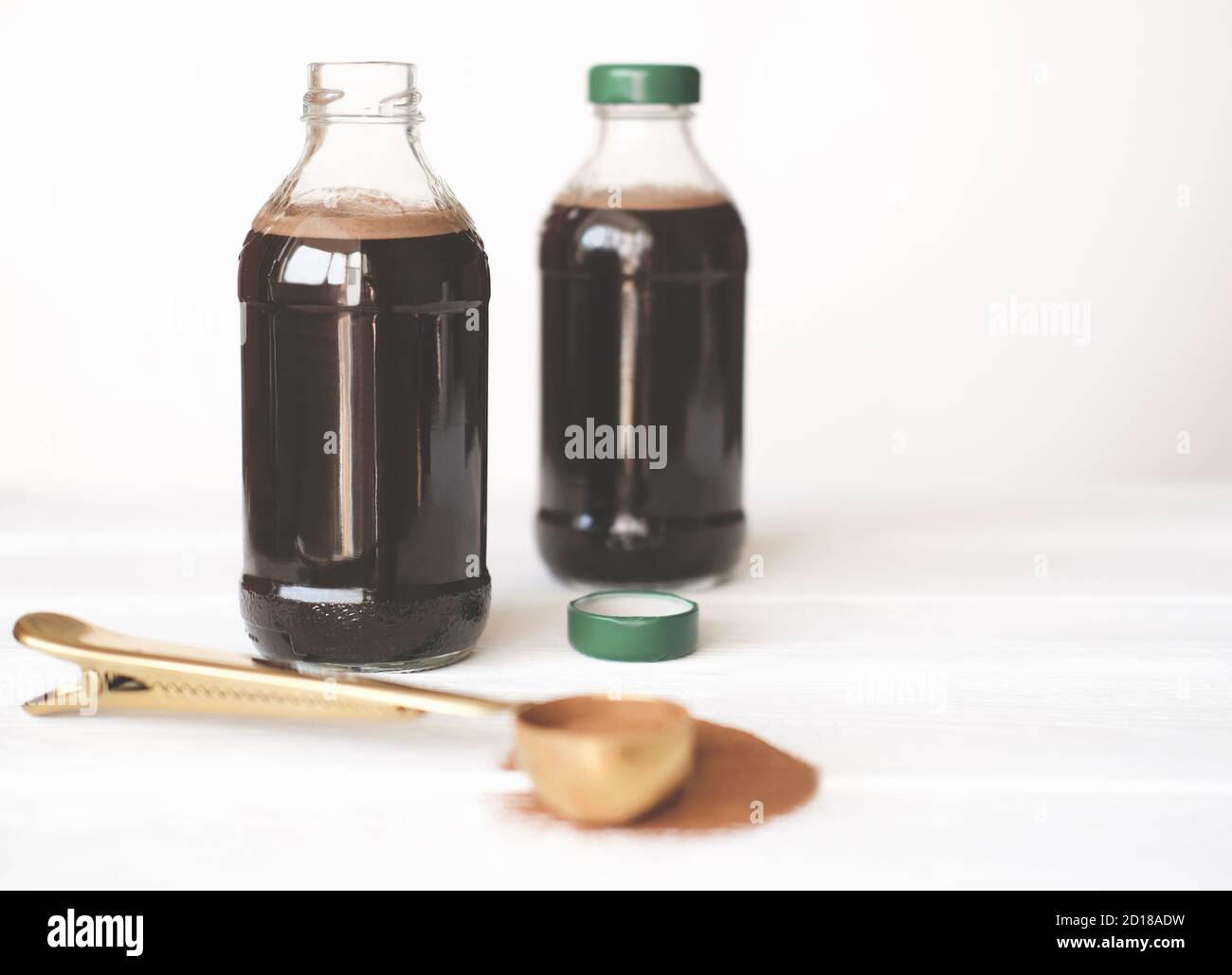 cold brew coffee in bottles and spoon with coffee. trendy coffee to go ...