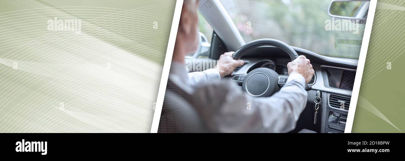 Man driving a car with his two hands on the steering wheel. panoramic ...
