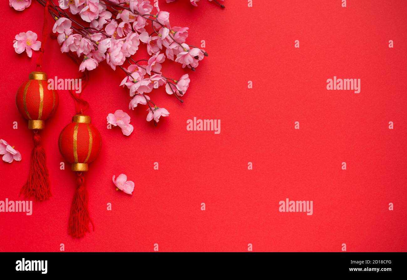 Flowers of good fortune and traditional accessories on red Stock Photo ...