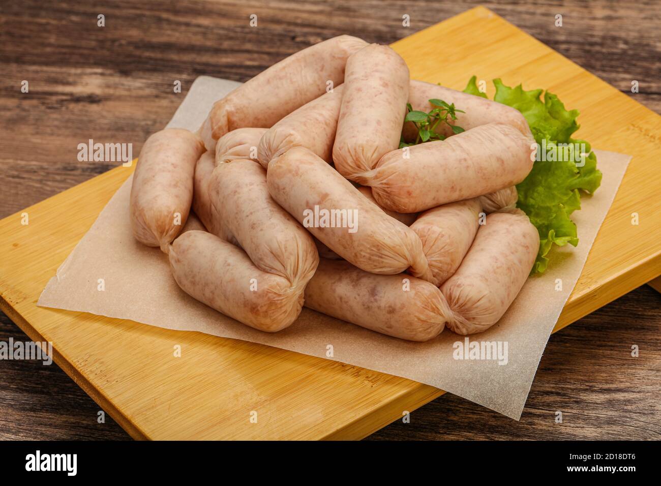 Raw natural chicken baby sausages for roast Stock Photo - Alamy